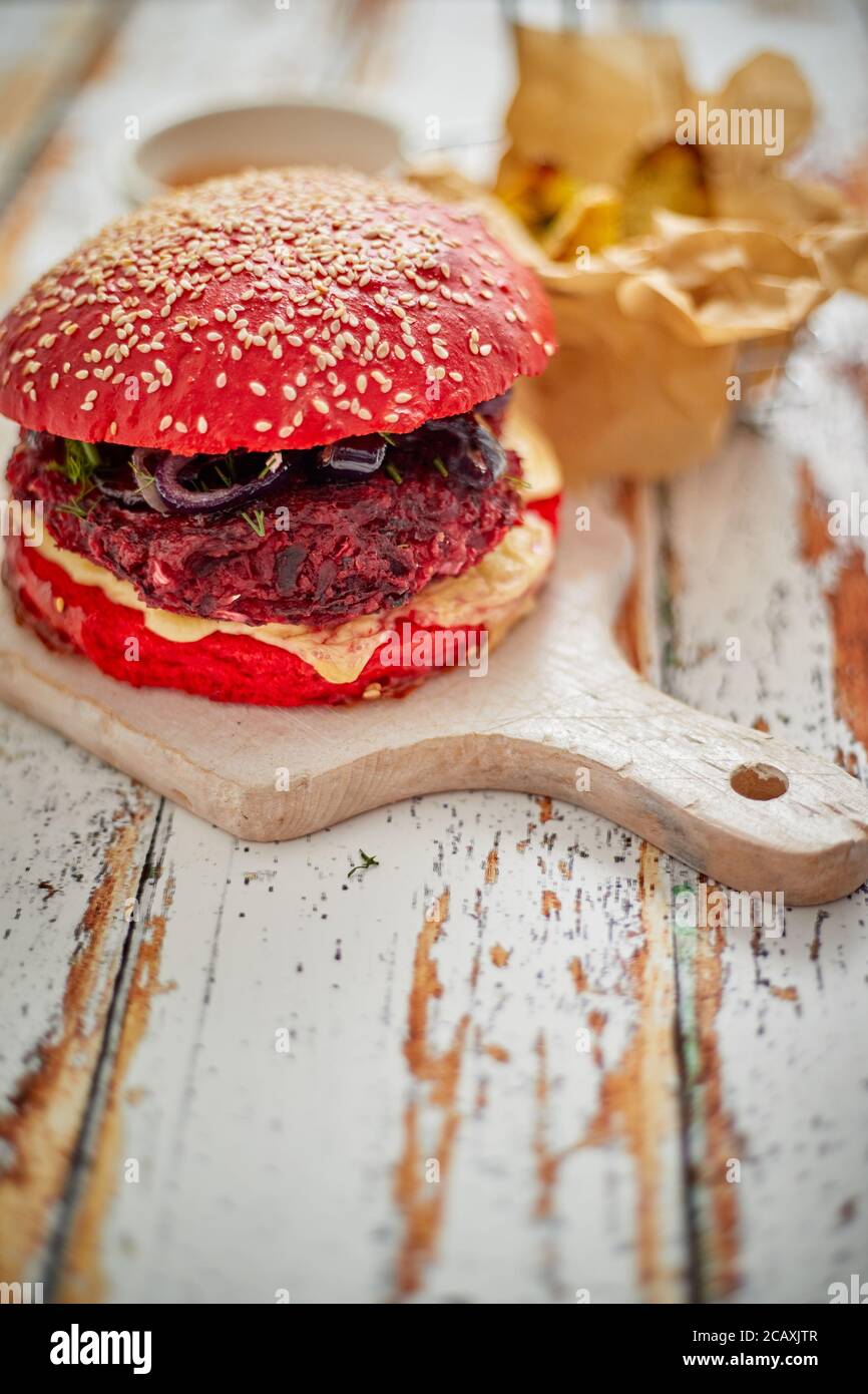 Homemade vegetable beetroot burgers. Red colored sesame bun. Served ...