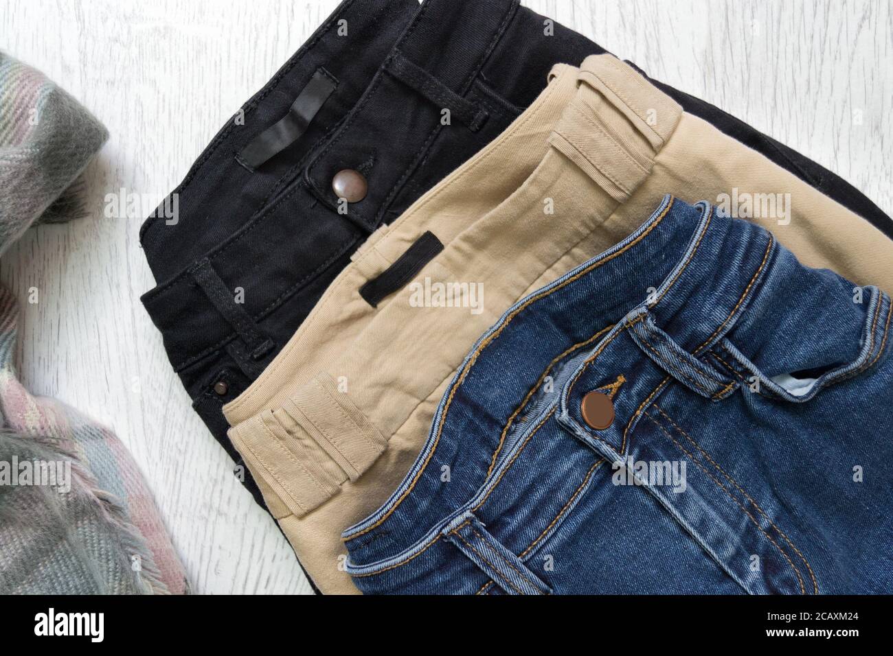 Three jeans, assortment. Blue, beige and black. Fashionable concept Stock Photo - Alamy