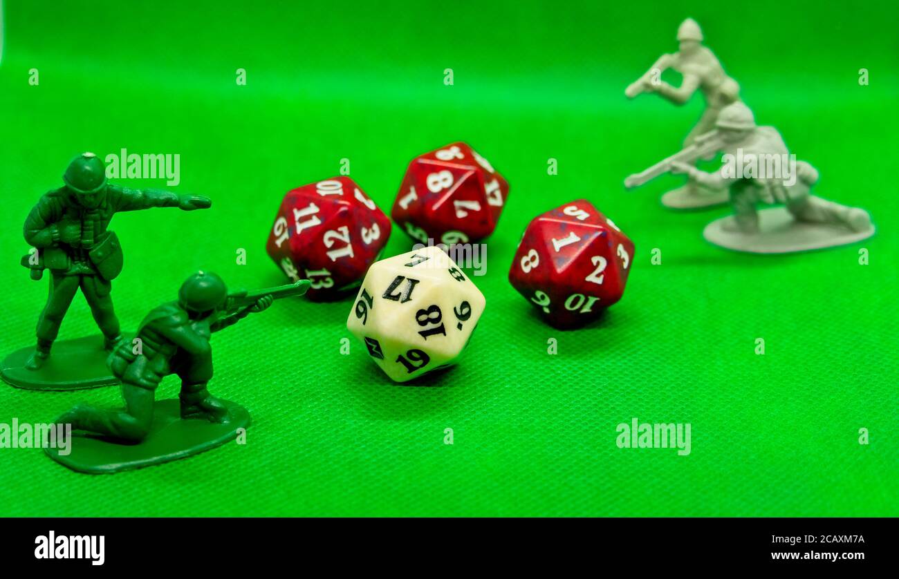 Dice of role-playing and figures of soldiers with a green background ...