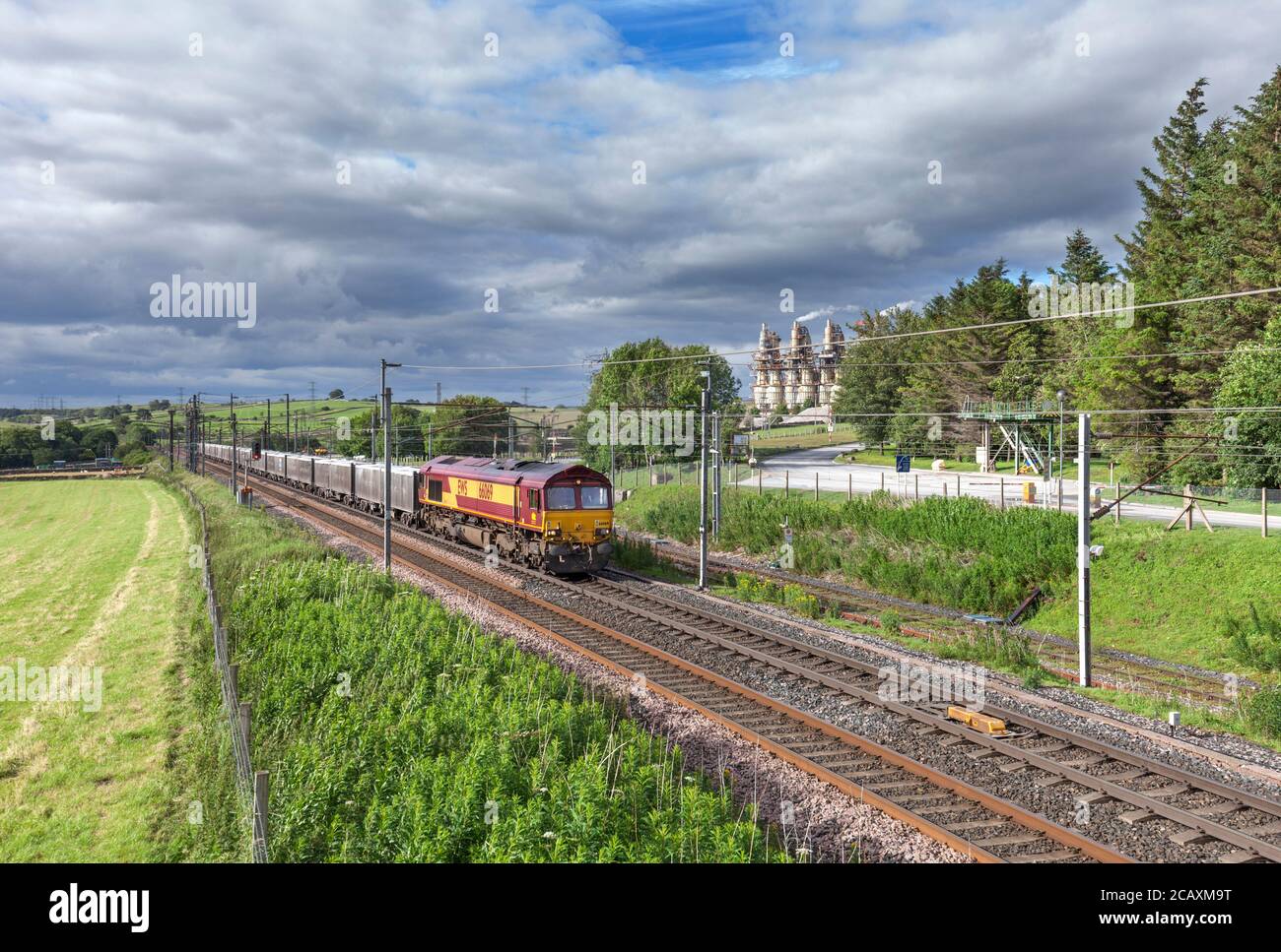 DB Cargo class 66 locomotive hauling a freight train carrying lime away ...