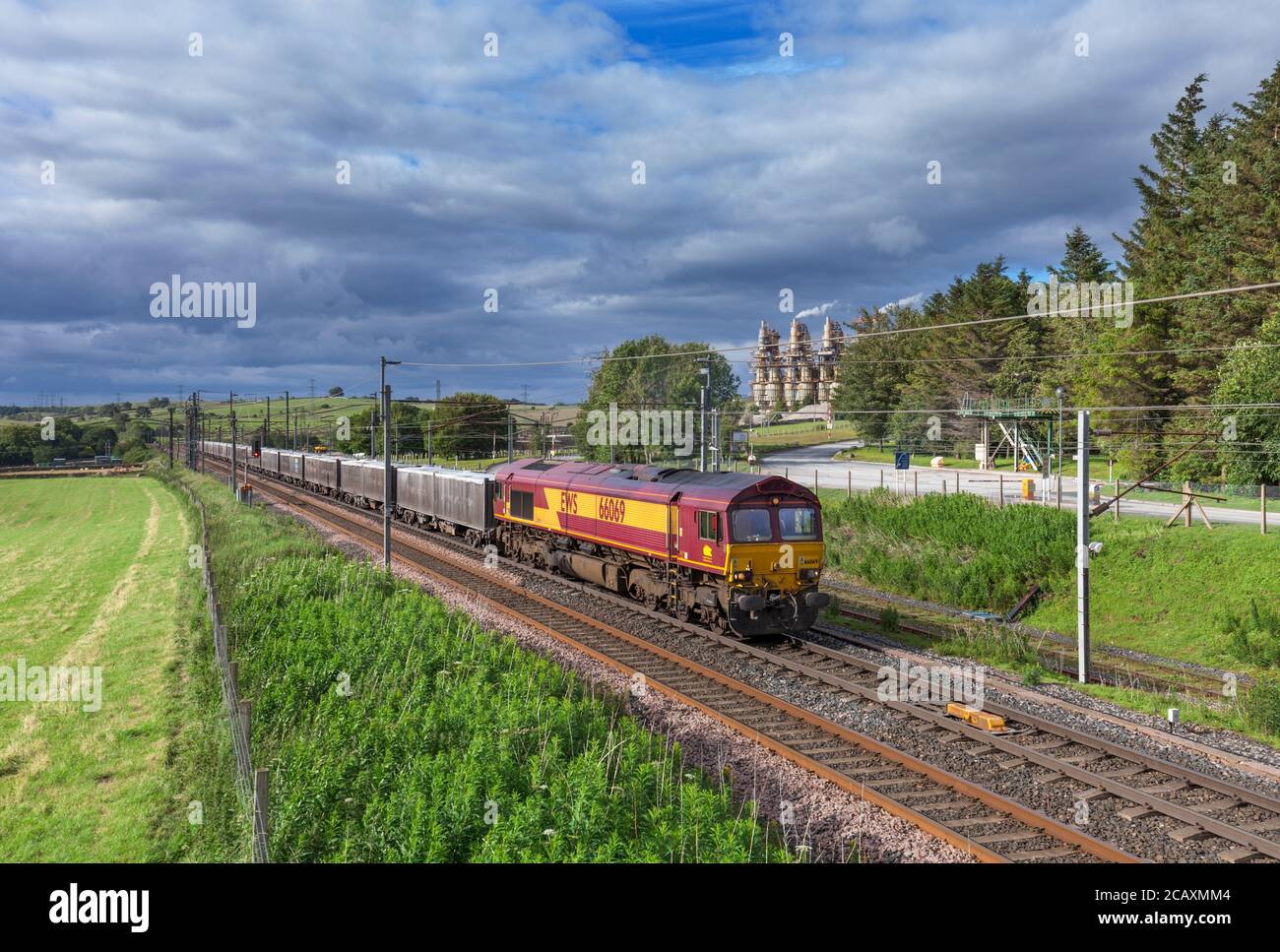 DB Cargo class 66 locomotive hauling a freight train carrying lime away ...