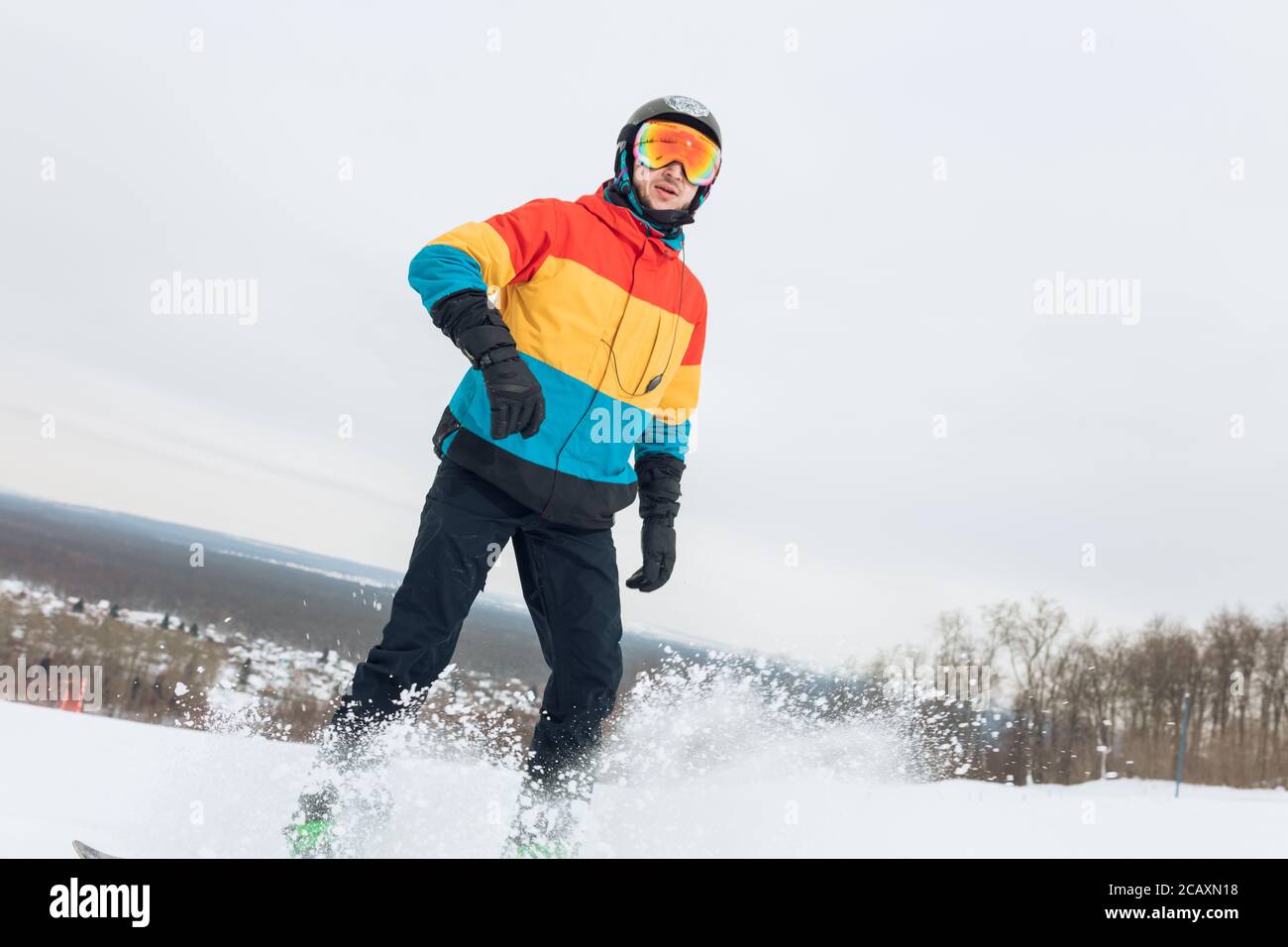 attractive stylish sportsman learn the basic position of snowboarding ...