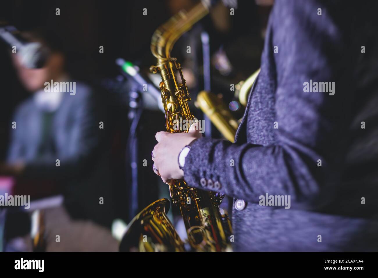 Concert view of a female saxophonist, professional saxophone player ...