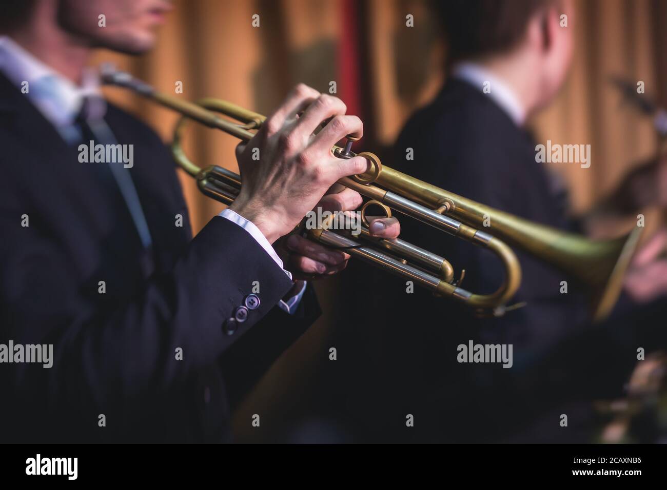 Concert view of a male trumpeter, professional trumpet player with ...
