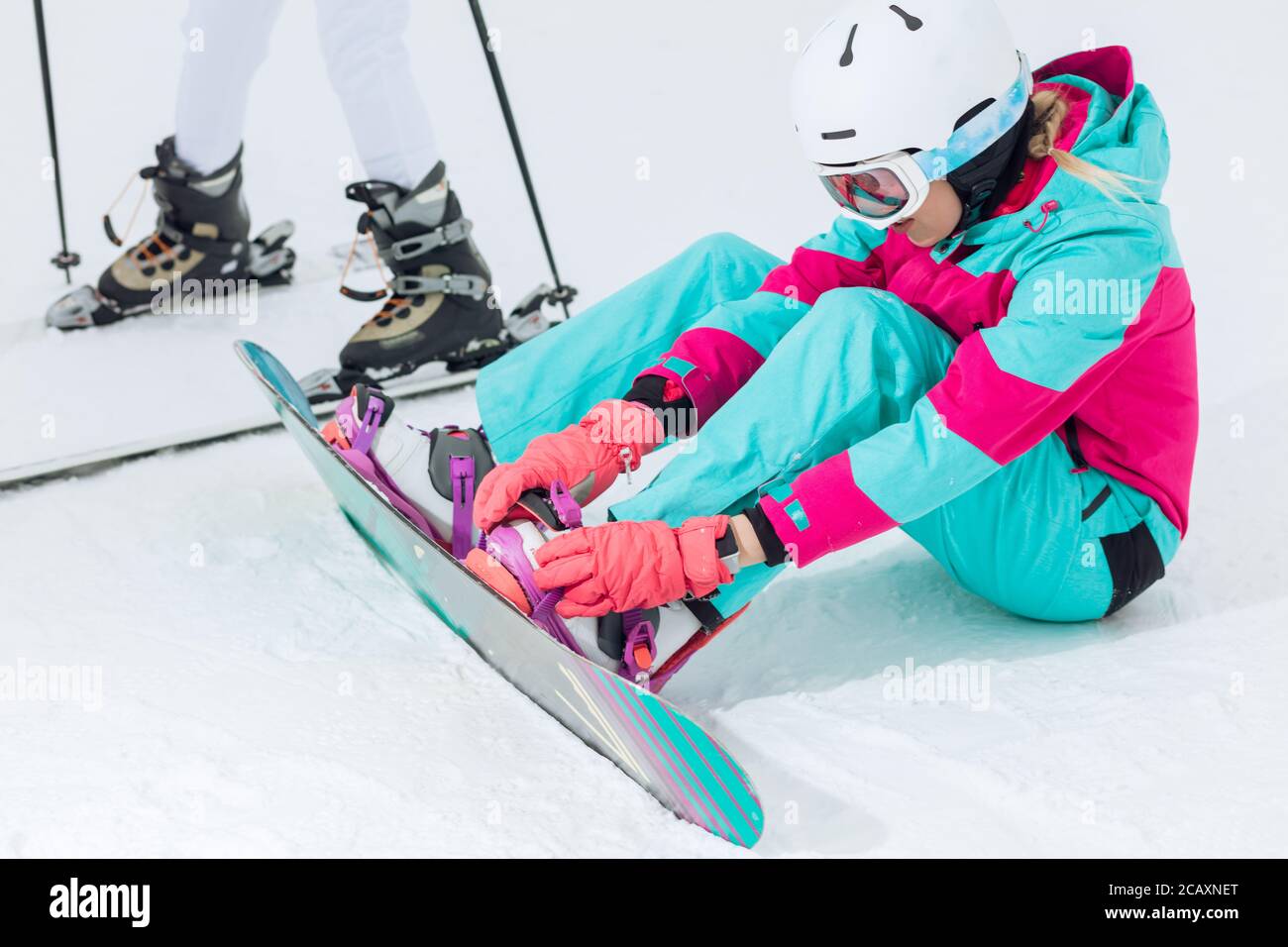 Strapping into snowboarding hi-res stock photography and images - Alamy