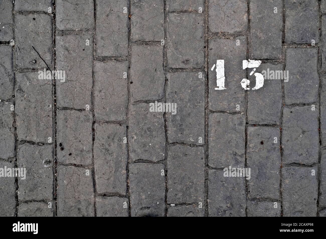 13, number thirteen, white stencil number on cobblestone surface Stock ...