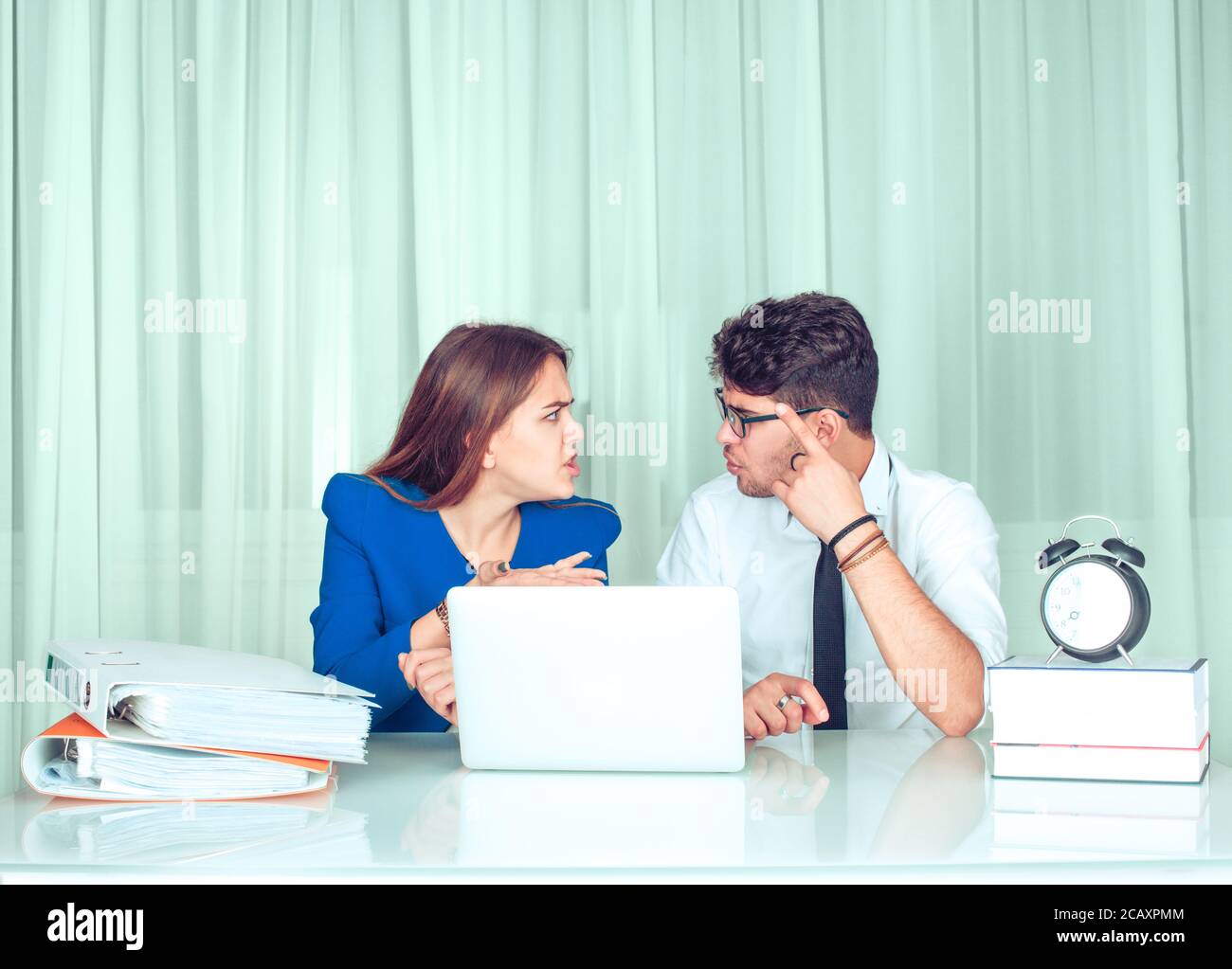 Are you crazy, what are you doing? Angry couple colleagues man woman ...