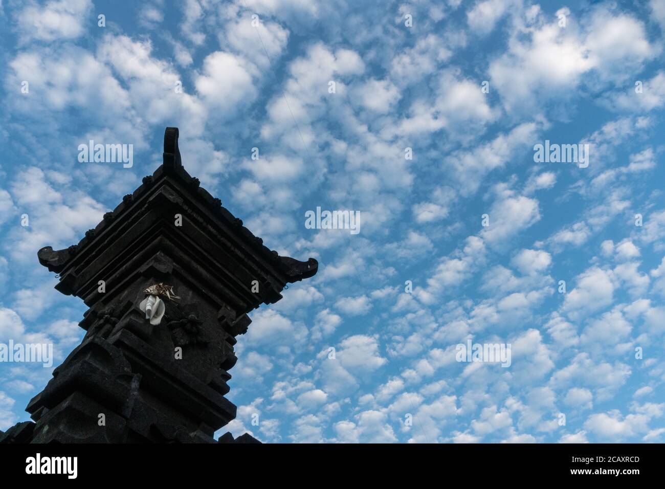 Cumulus cloud in the sky with beautiful Balinese building or statue as ...