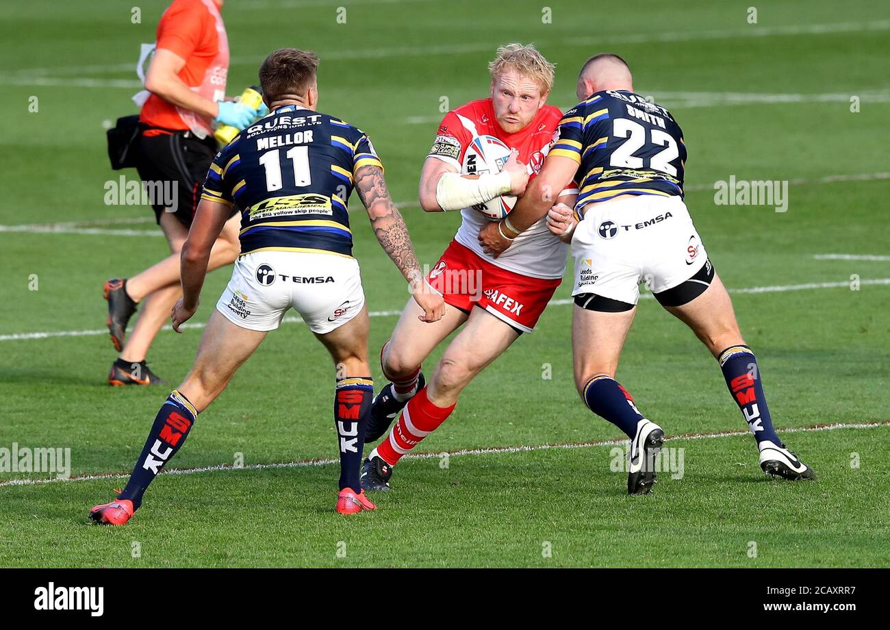 St Helens' James Graham (centre) is tackled by Leeds Rhinos' Alex ...