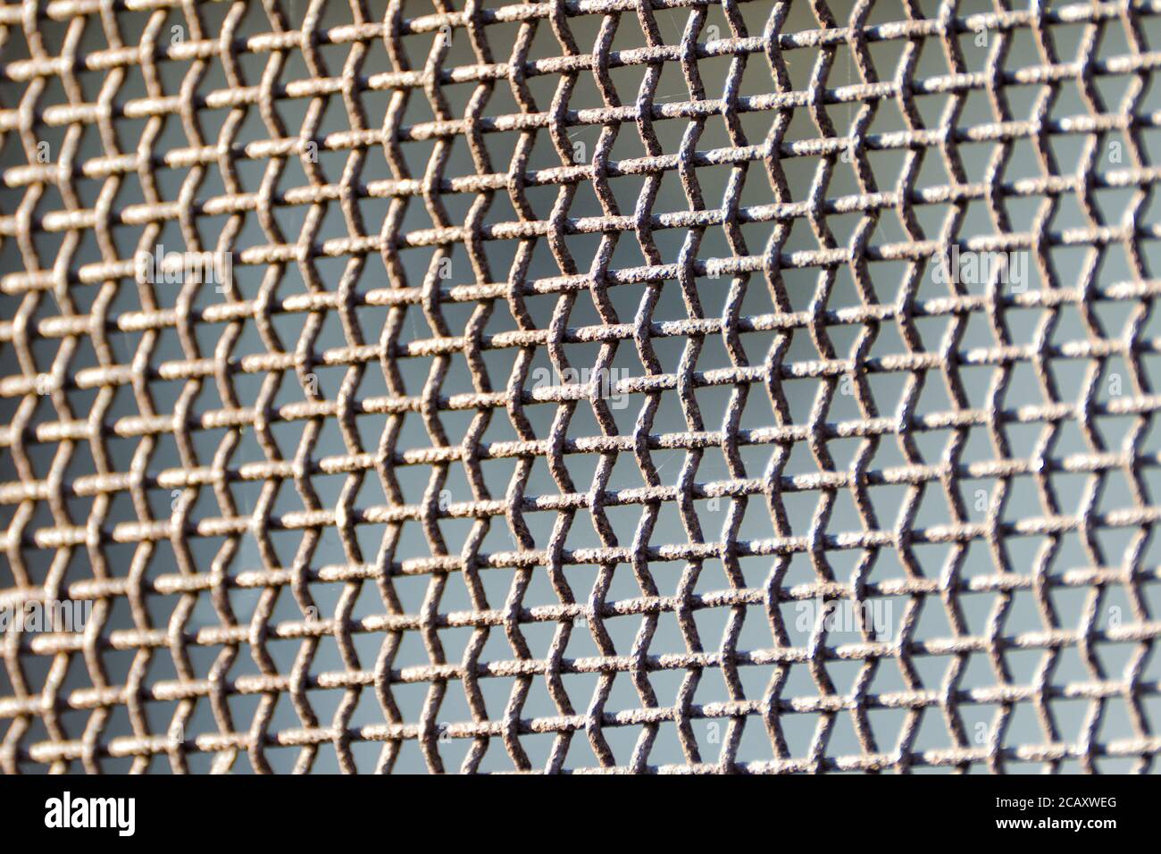 Rusty fence made of fine metal mesh. Side view Stock Photo - Alamy