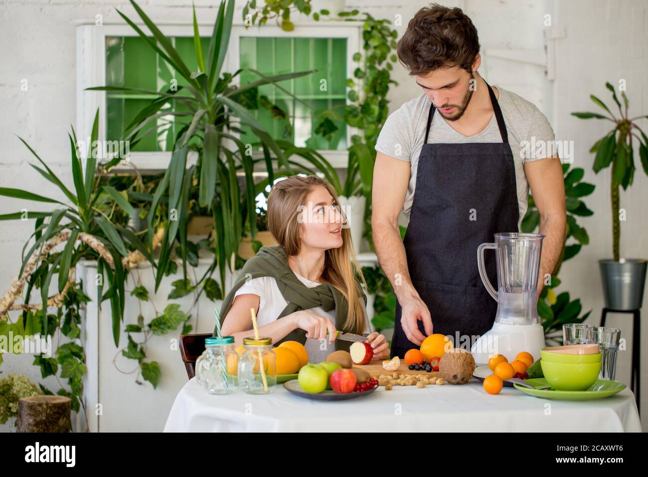 awesome chef showing the girl how toprepare tasty fresh drink. close up ...