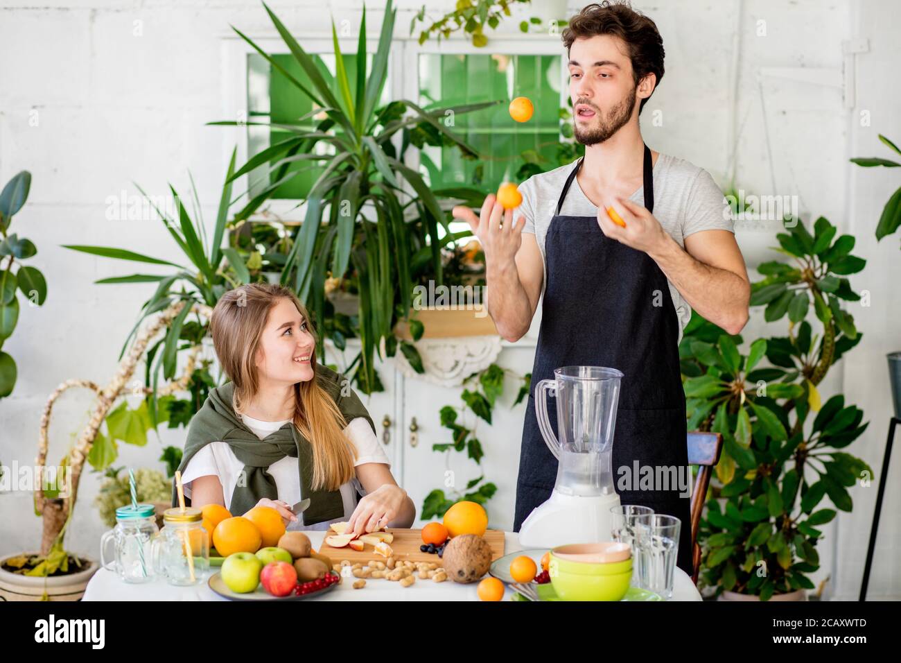 awesome chef is throwing mandarins while his excited girlfriend is ...