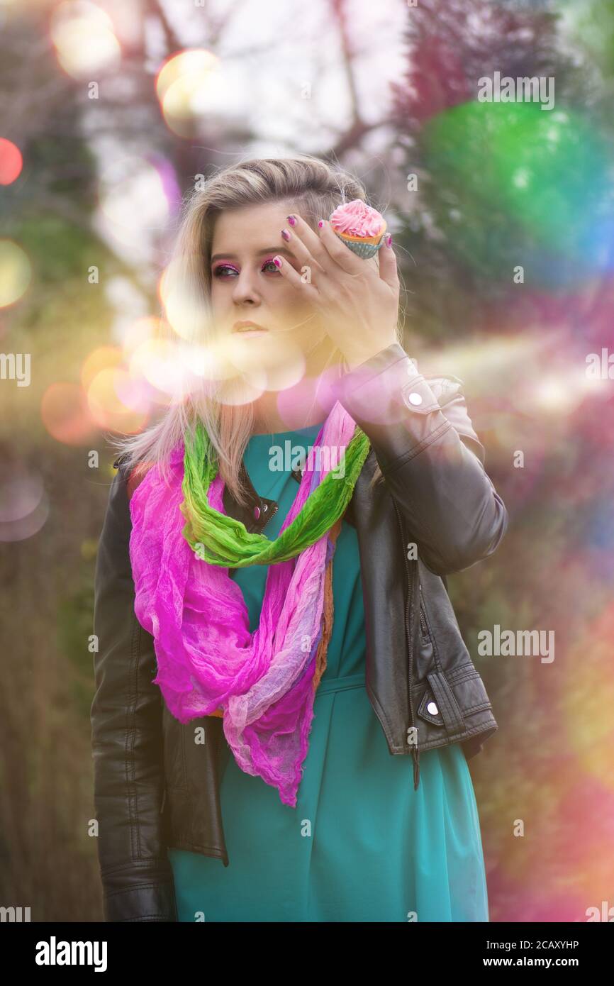 Young fashion model girl with cookie in hand. Romantic lady eating ...
