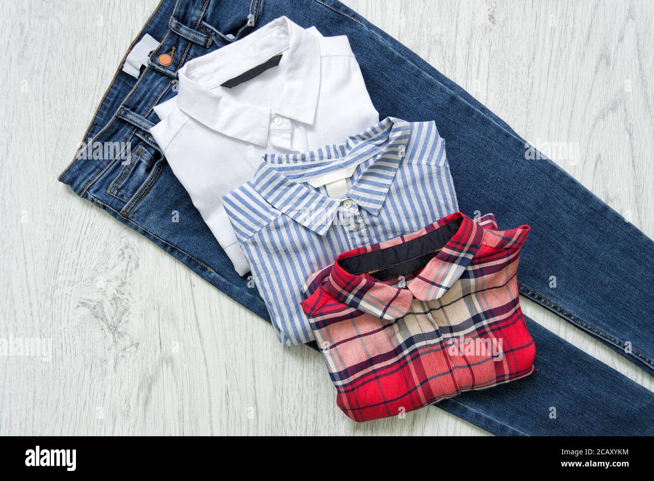 Three shirts on jeans, white, checkered, striped. Collage. Fashionable ...