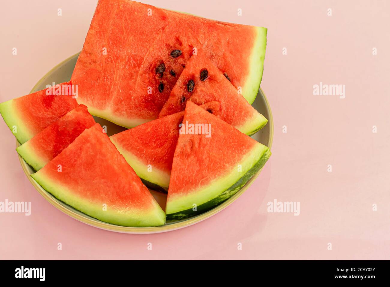 Delicious red sliced watermelon on a plate. Stock of fiber and fructose ...