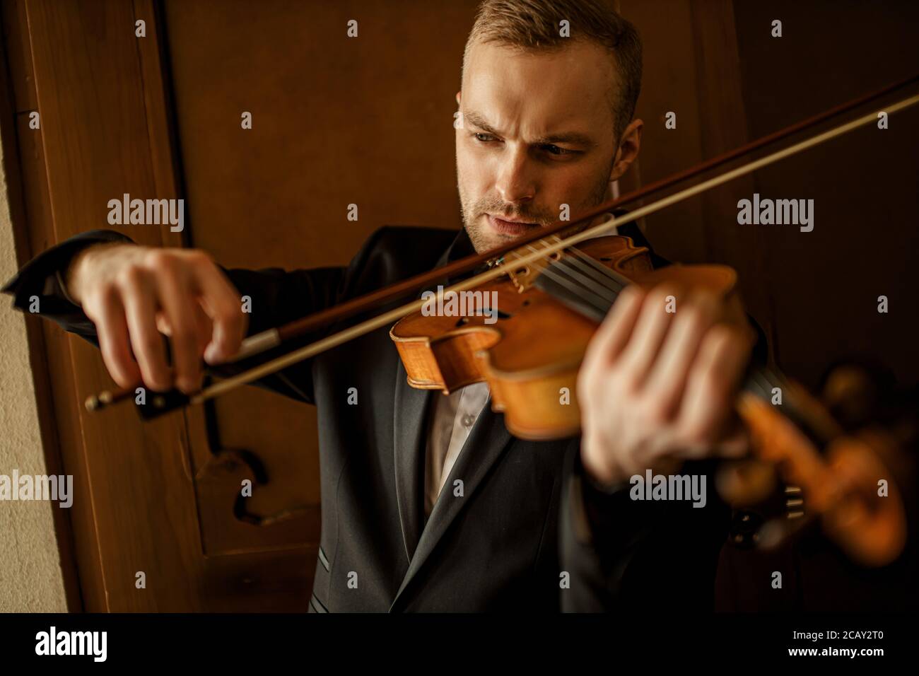 handsome caucasian guy with classic instrument violin, talented male ...