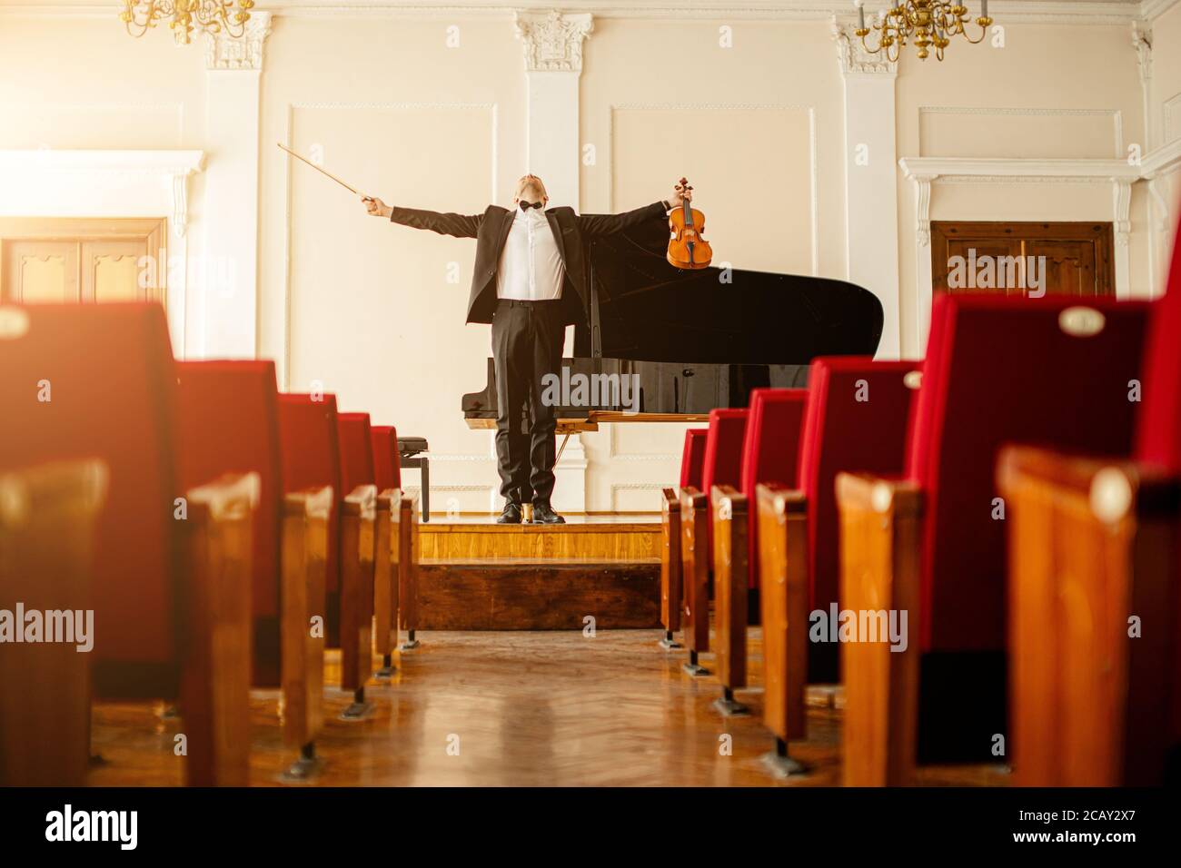 professional male musician with violin on a stage, violinist thanks ...