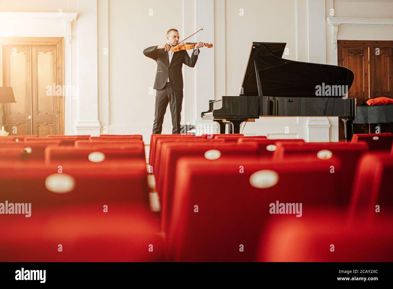 talented young caucasian man practice playing violin on a stage ...