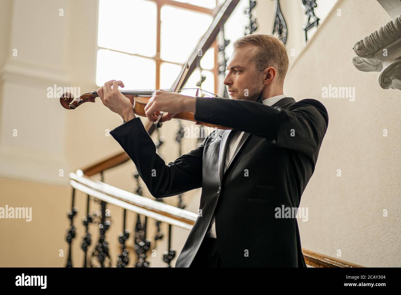 handsome caucasian guy in elegant suit practice playing violin, man ...