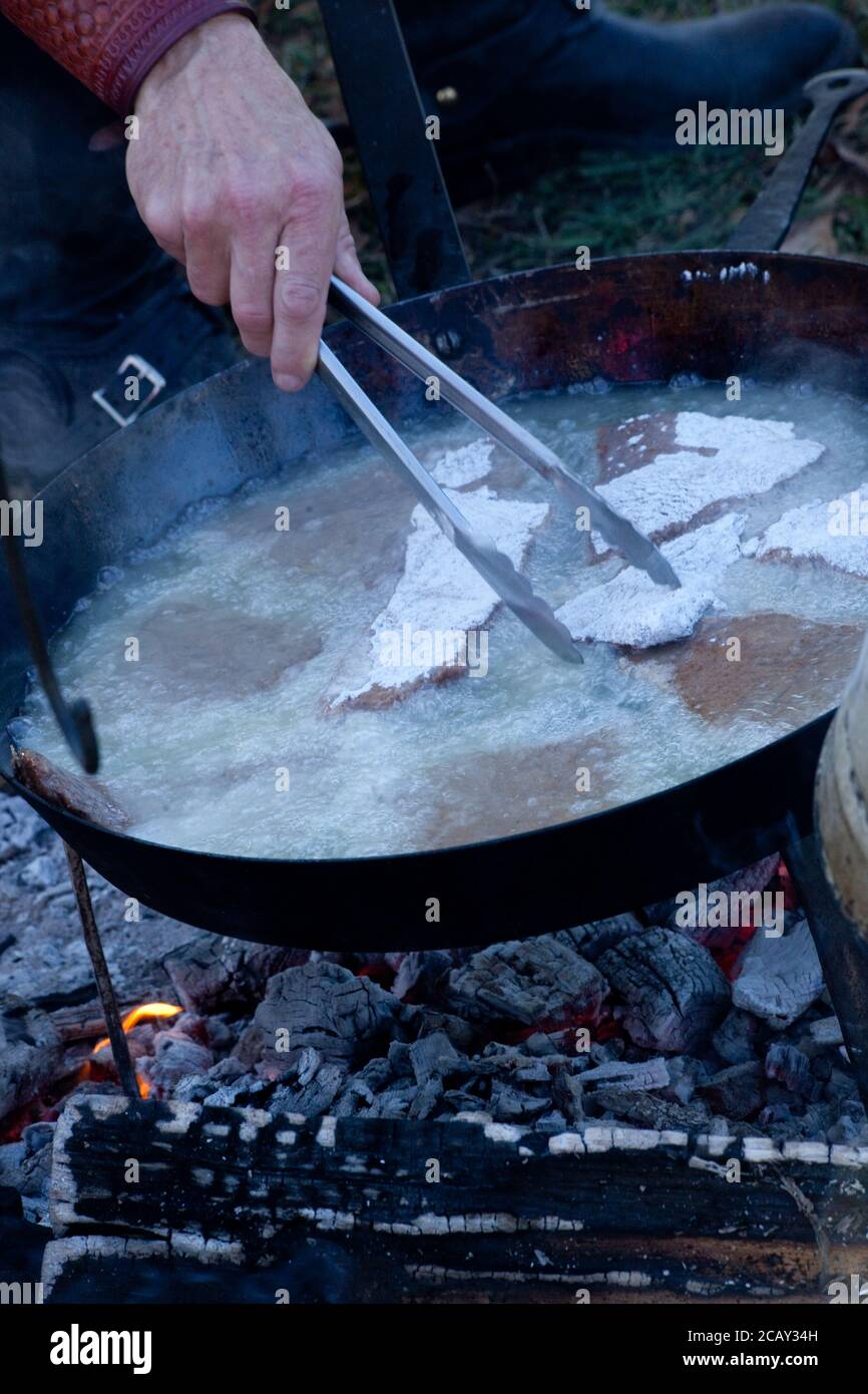 Cowboy cooking a meal over an open fire Stock Photo - Alamy
