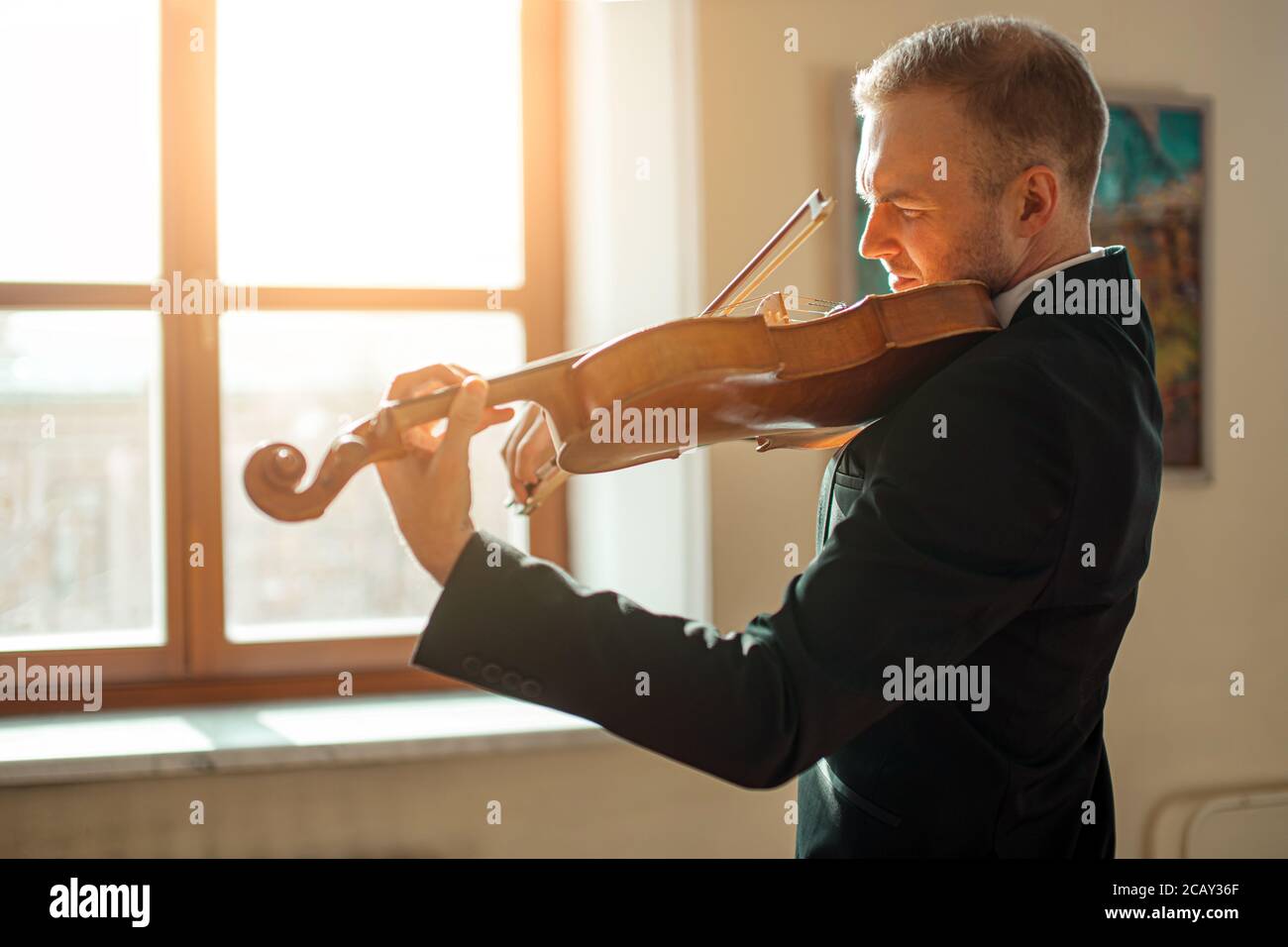 handsome caucasian guy with classic instrument violin, talented male ...