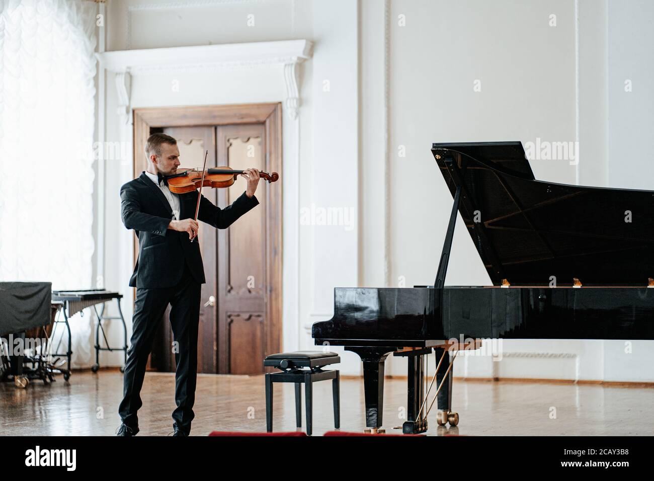 young talented professional man gracefully play violin, handsome ...