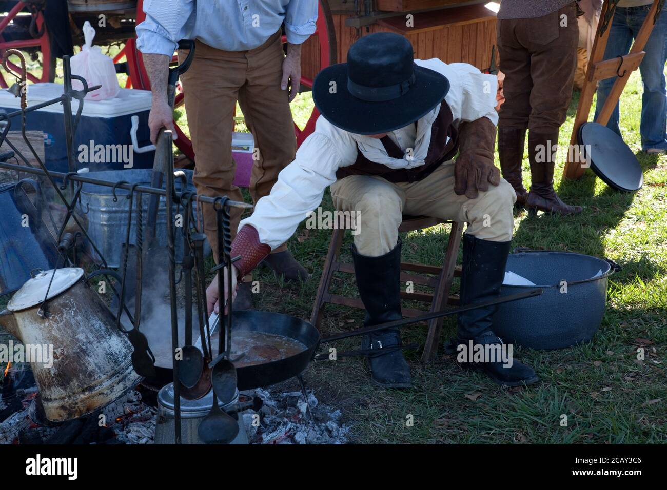 Cowboy cooking a meal over an open fire Stock Photo - Alamy