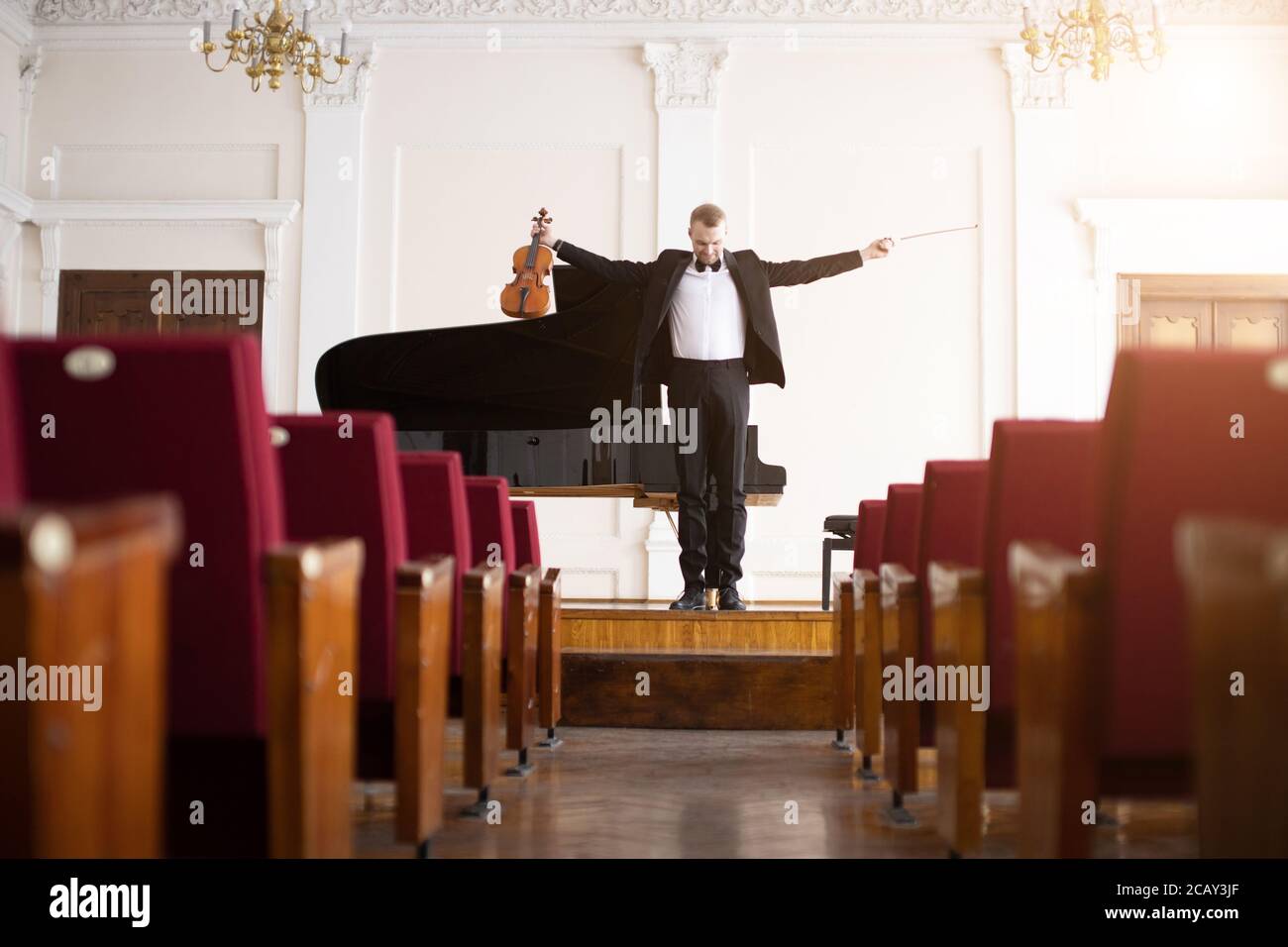 professional caucasian male violinist after performance on a stage. man ...