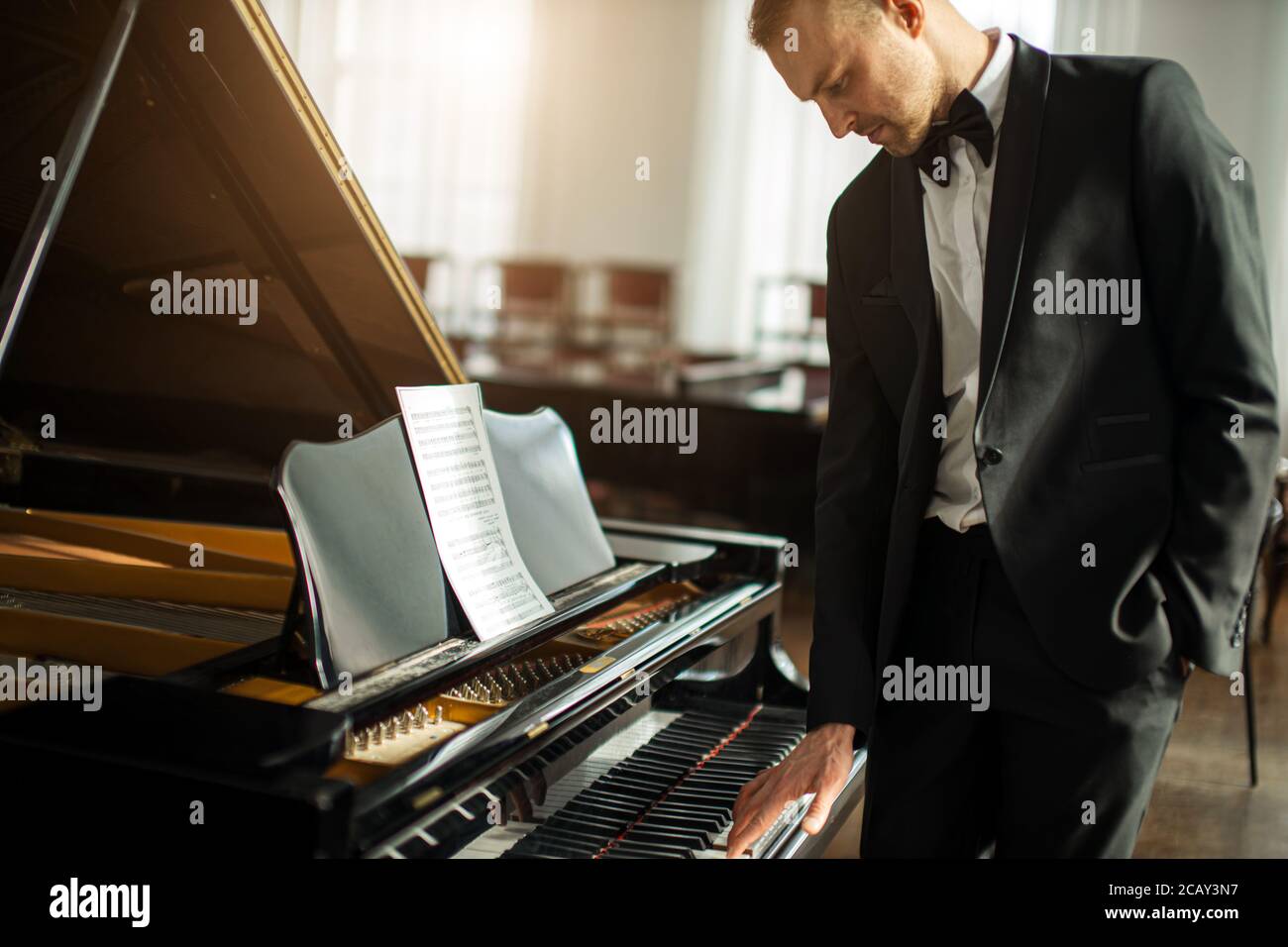 talented young caucasian pianist man practicing, perform awesome music ...