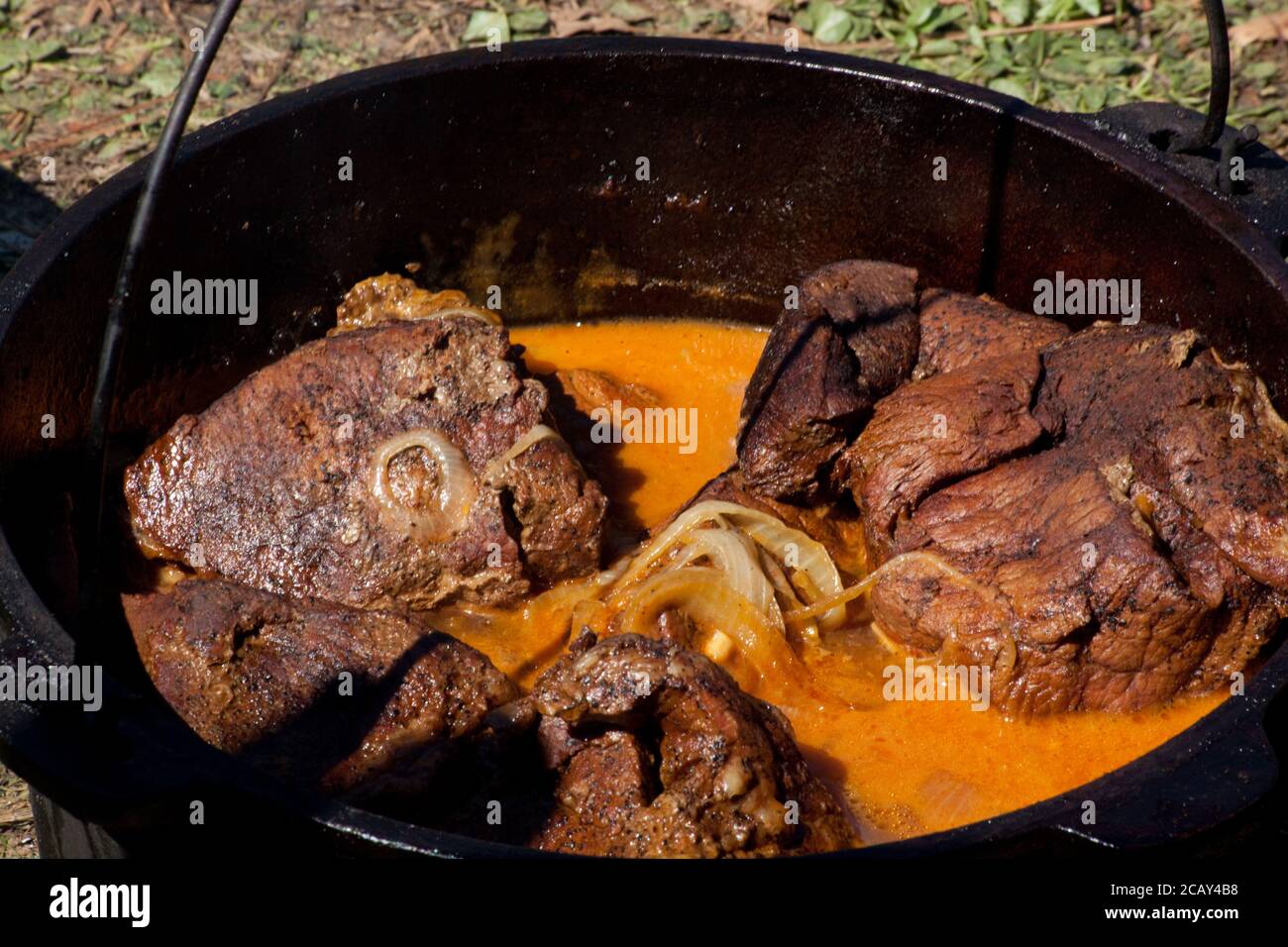 Cowboy cooking a meal over an open fire Stock Photo - Alamy