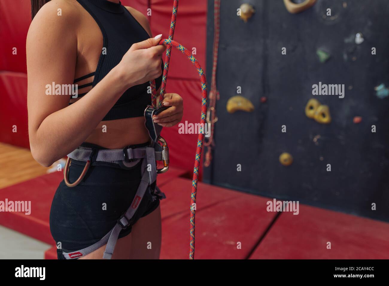 slim fit girl with a belt and rope on her body is ready for rock ...