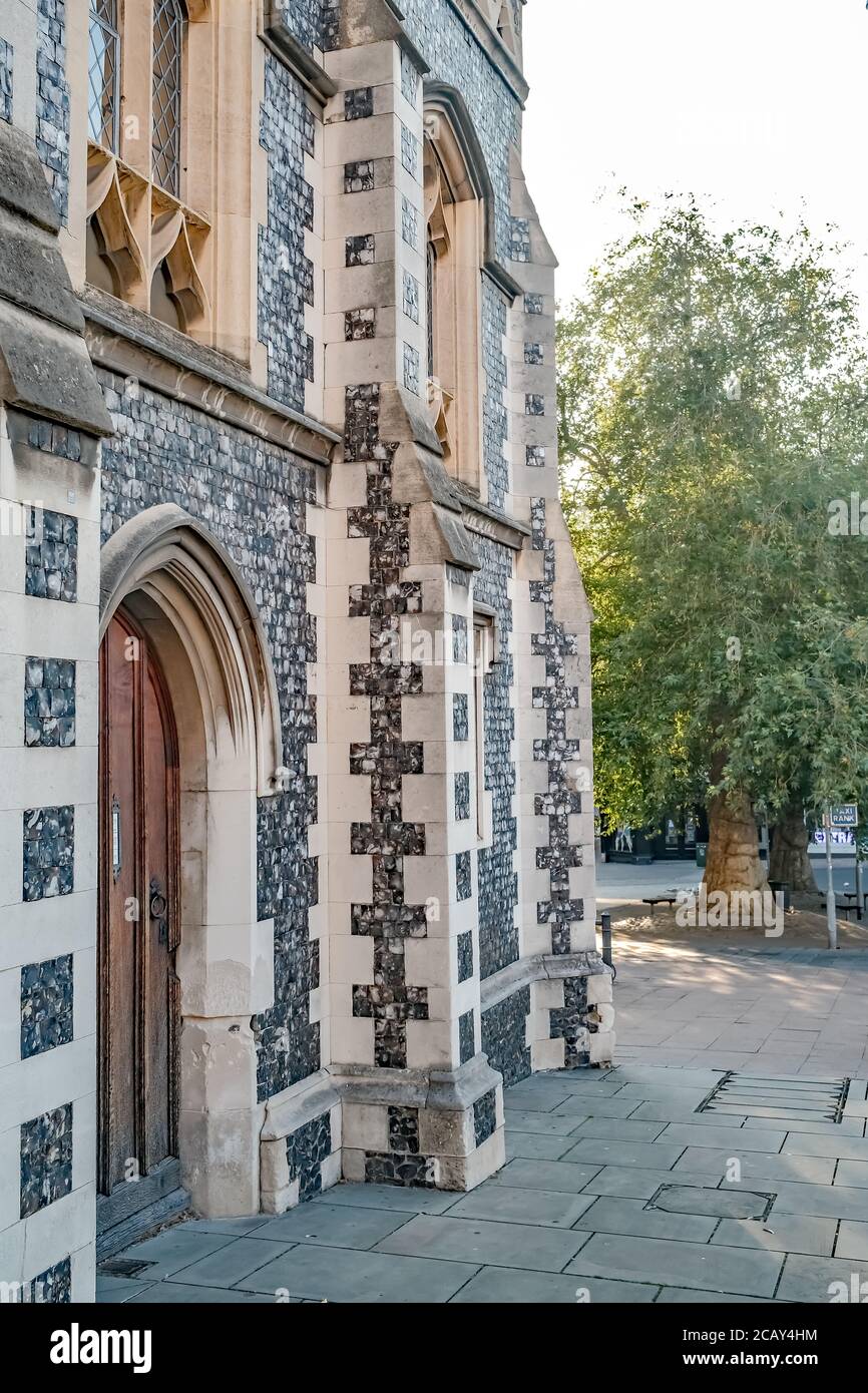 Side on view of the historical flint built Guildhall in the city of ...