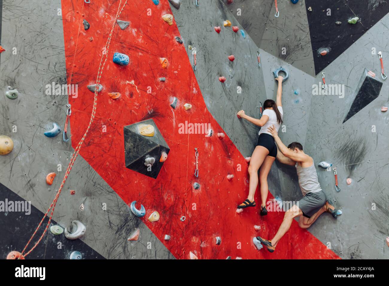 Strong man supporting slim girl. Free-time fitness activity. People ...