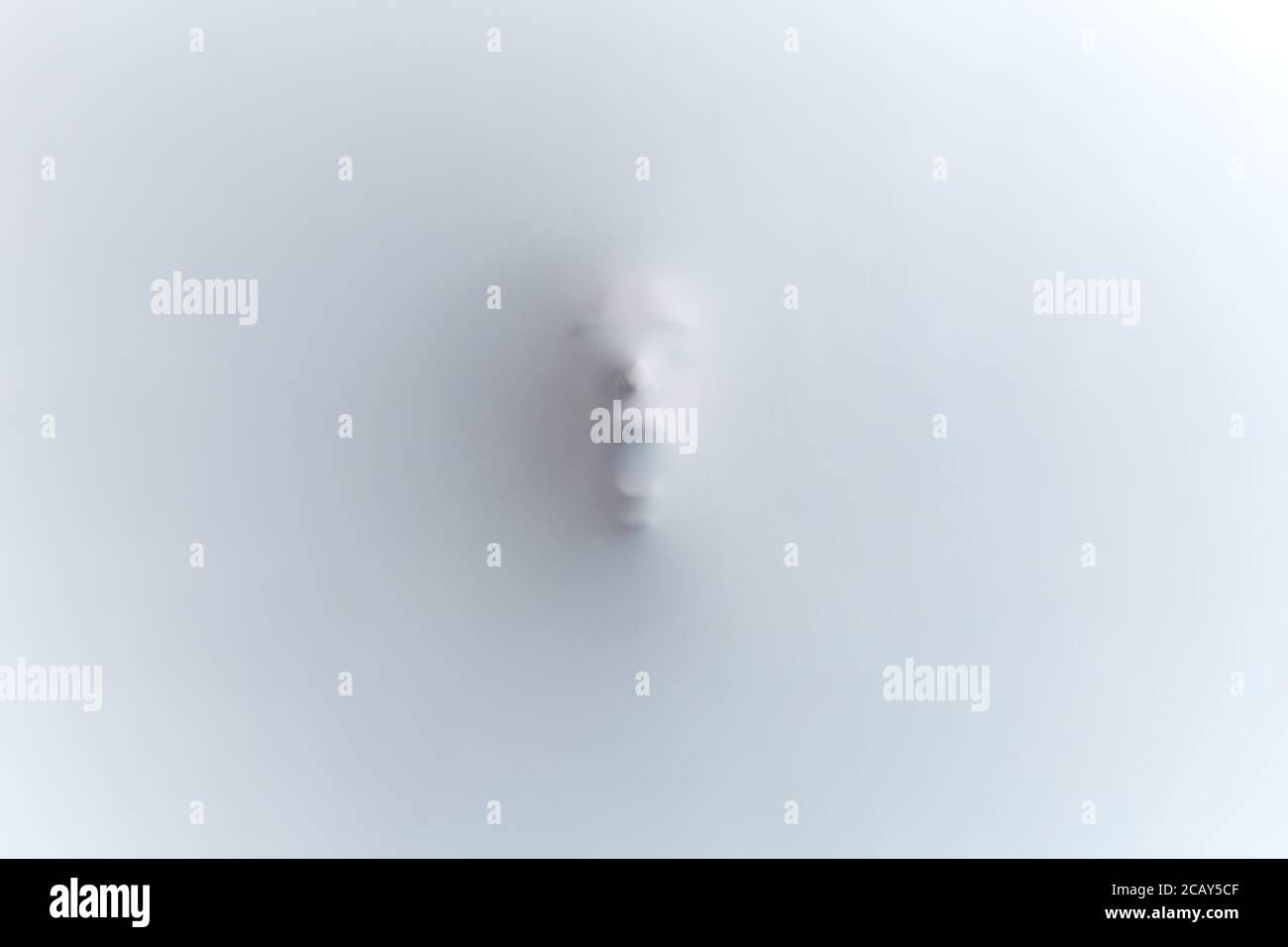 Shadow blur of crying screaming man.Dangerous man behind the frosted ...