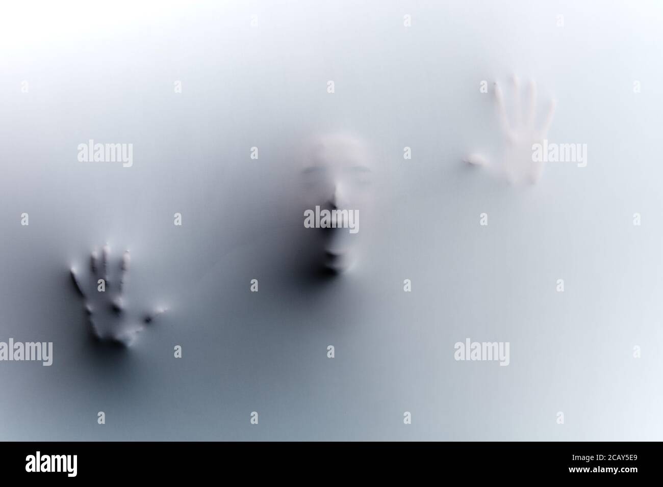 creative talented man dancing behind the glass wall. white and black ...