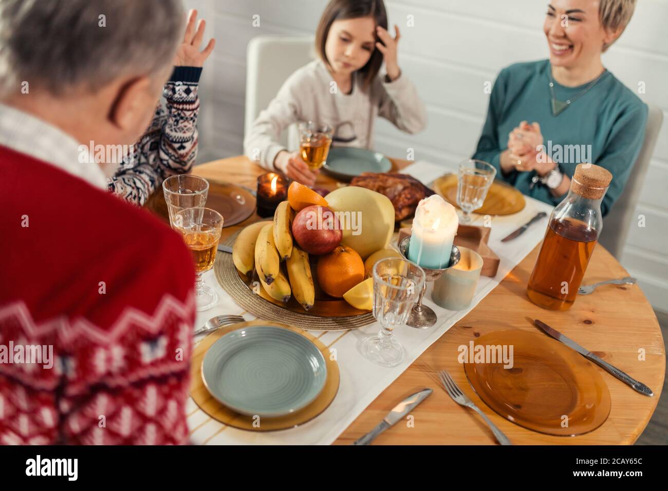 happy relatives are sitting around table in the kitchen. close up ...