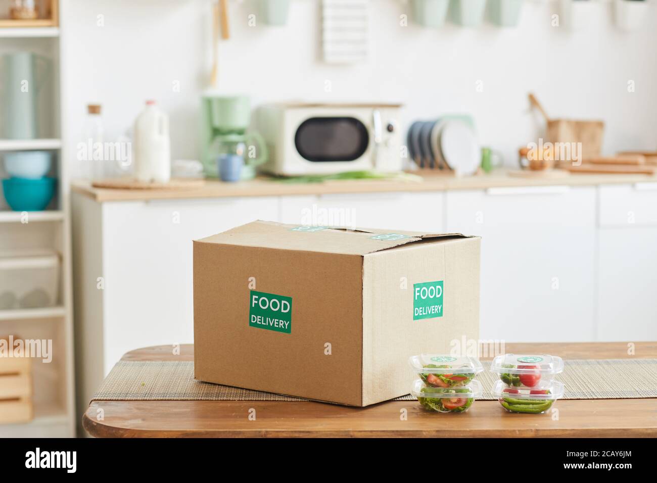 Background image of cardboard box with food standing on wooden table in ...