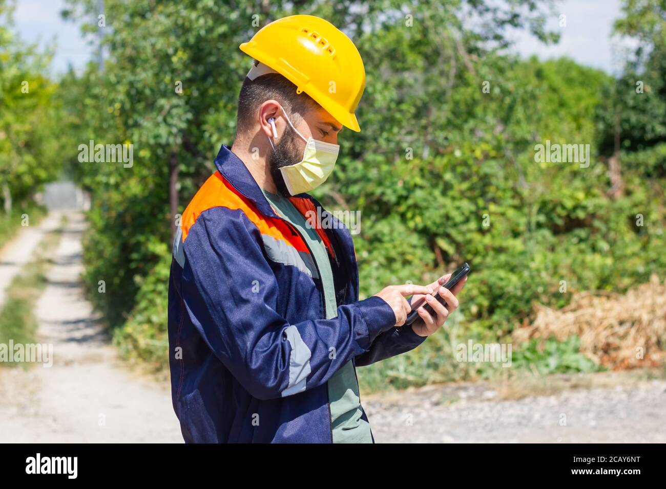 male architect in white helmet with blueprint Stock Photo - Alamy