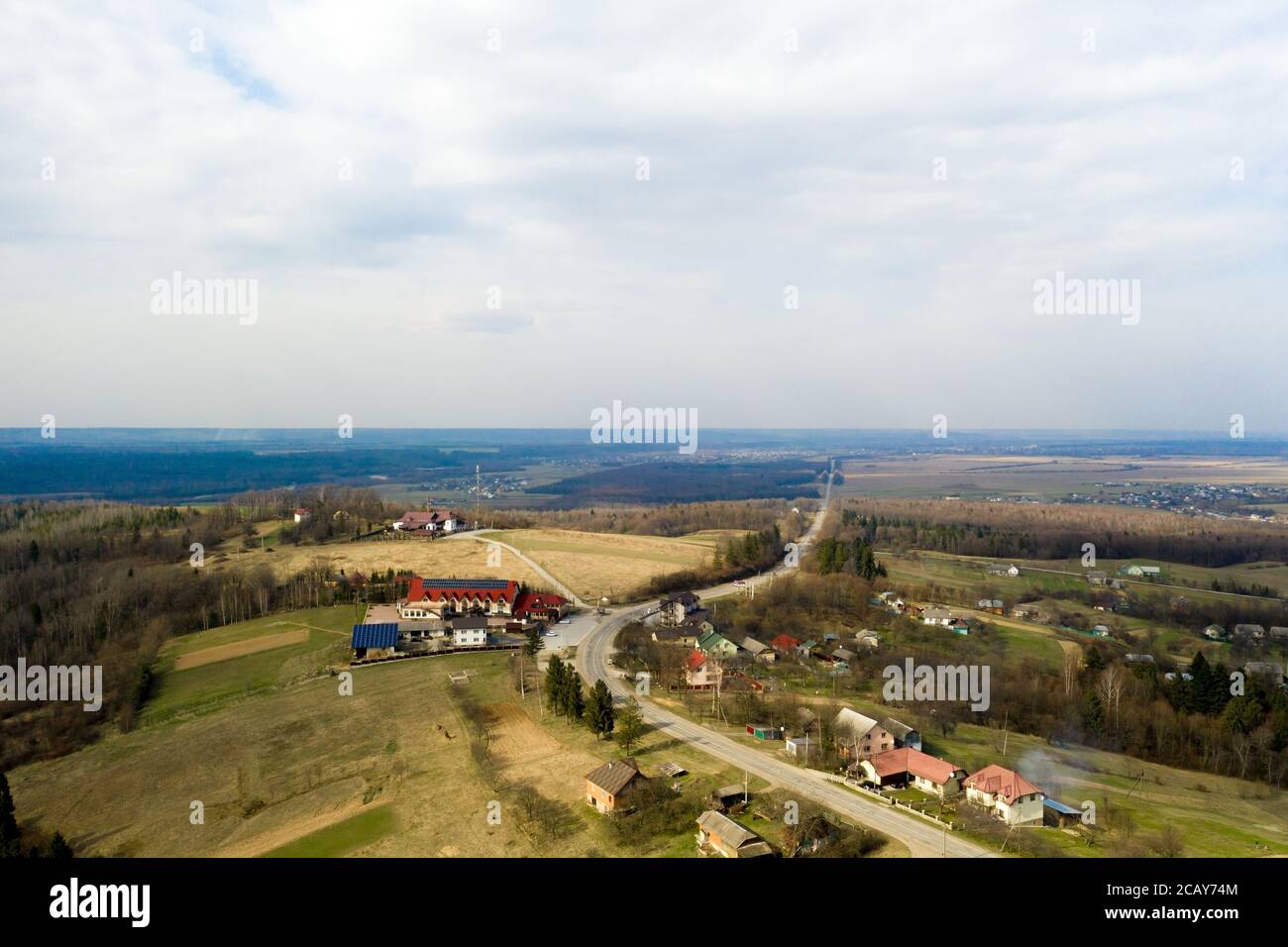 Countryside road, surrounded by lush green nature - Top down aerial ...