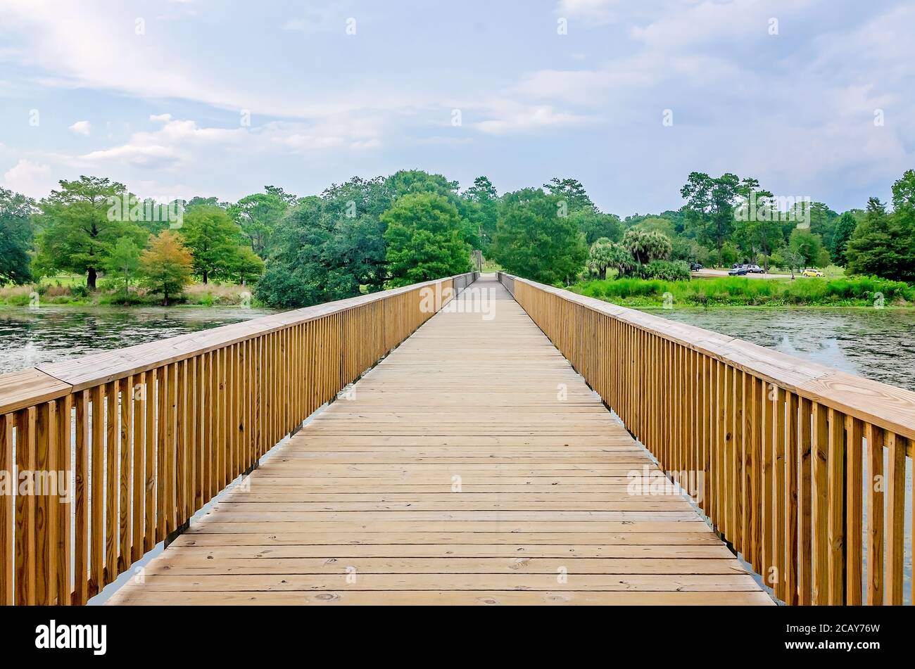 A wooden pedestrian bridge crosses the lake at Langan Park, Aug. 8 ...