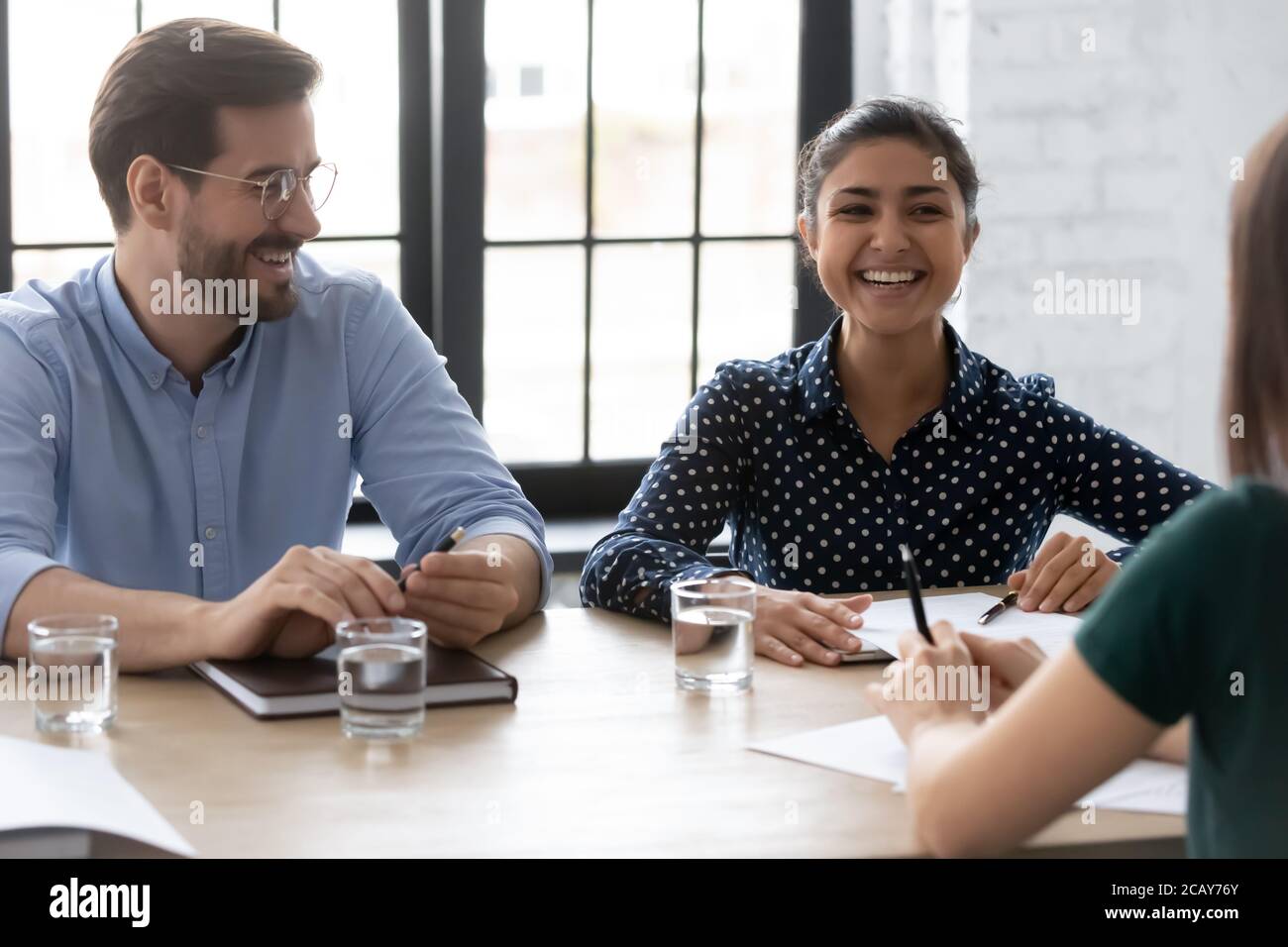 Happy diverse business people laughing at corporate meeting in ...