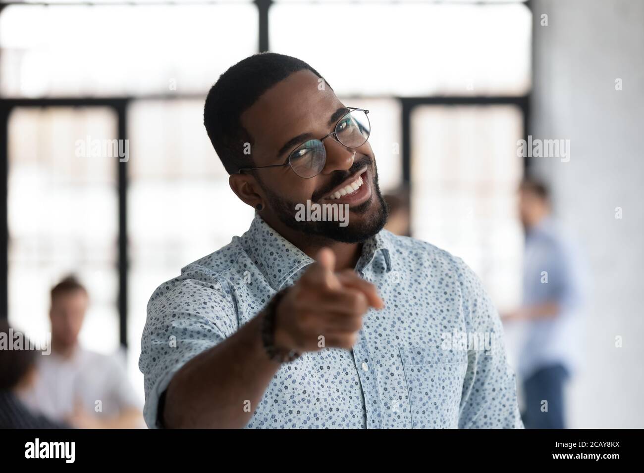 Head shot portrait smiling African American hr manager pointing finger ...