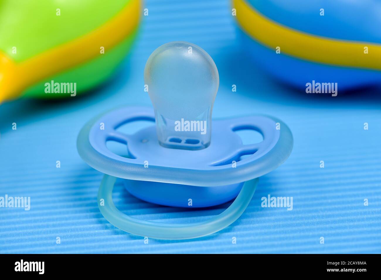 Baby pacifier on blue background, Pacifier on a blue background with a ...