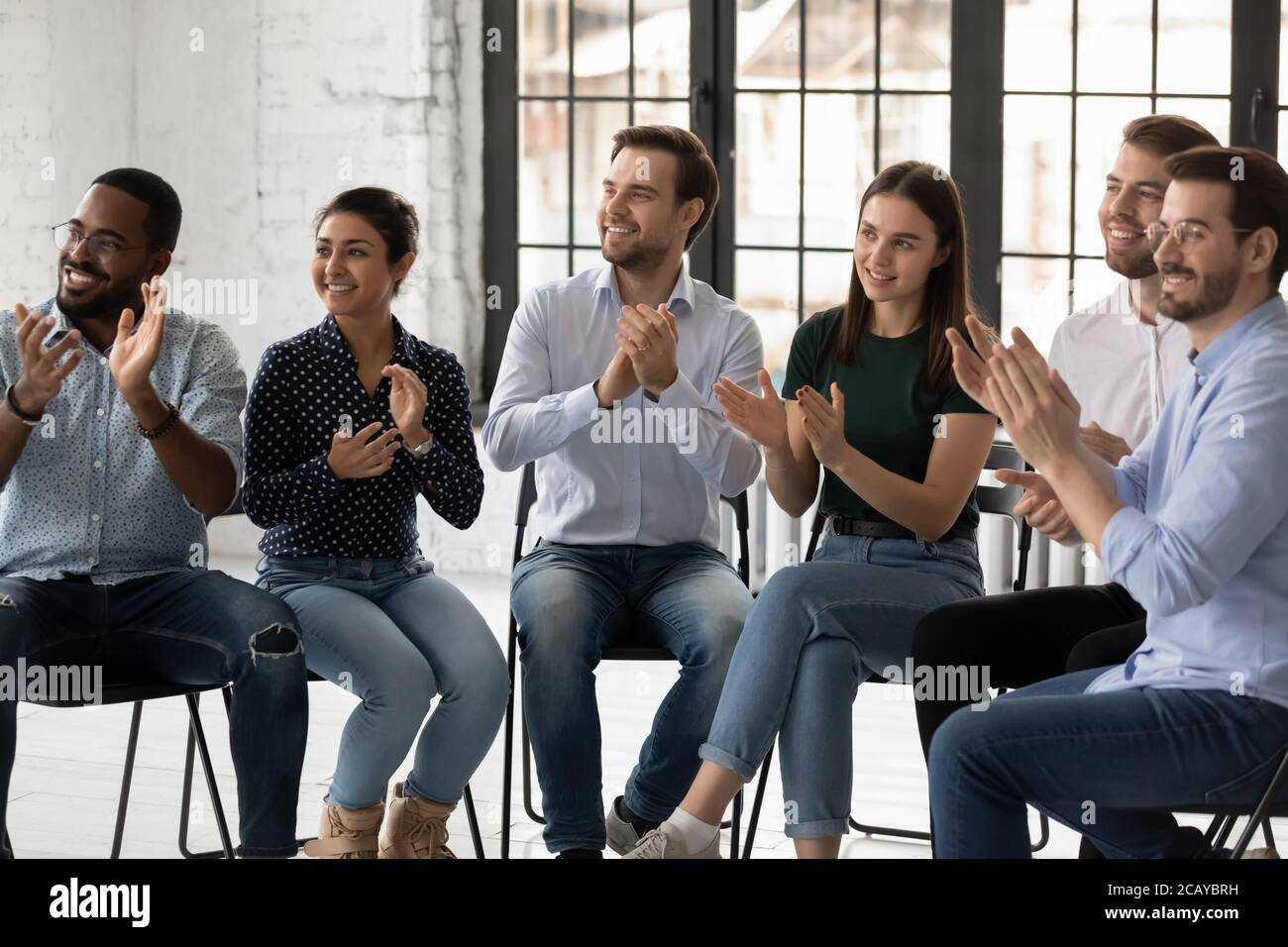 Smiling diverse employees applauding, clapping hands, cheering mentor ...