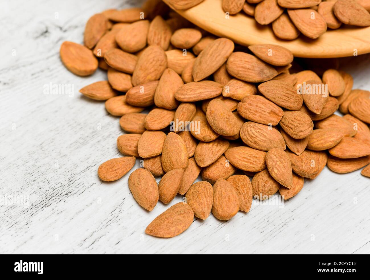 Almond nuts on the white rustic wooden background Stock Photo - Alamy
