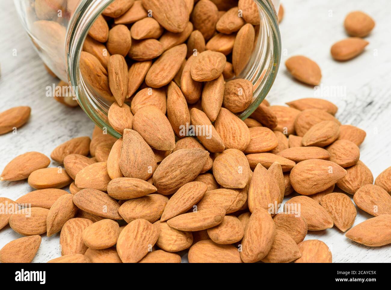 Almond nuts on the white rustic wooden background Stock Photo - Alamy
