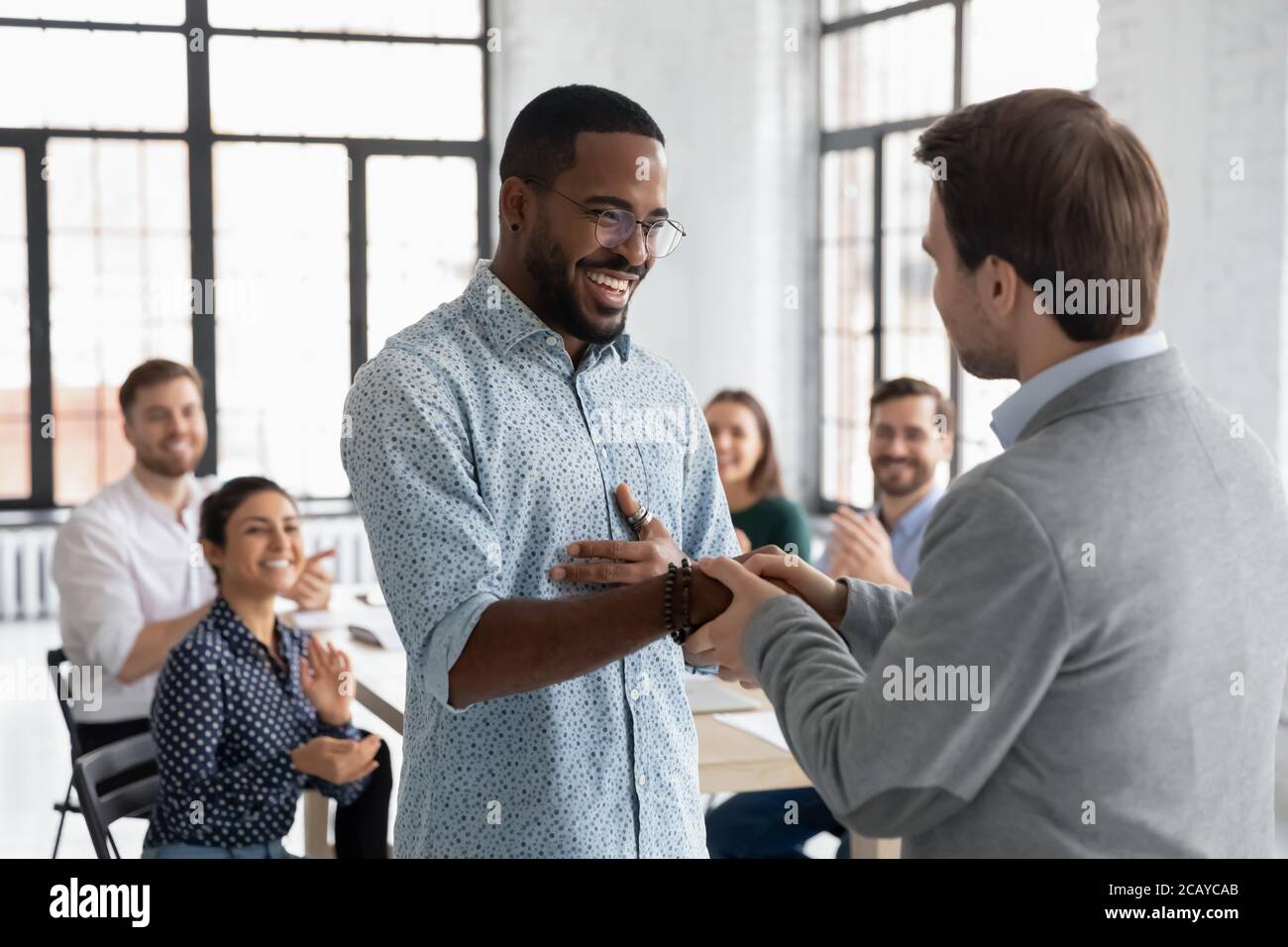 Close up executive shaking successful African American employee hand ...