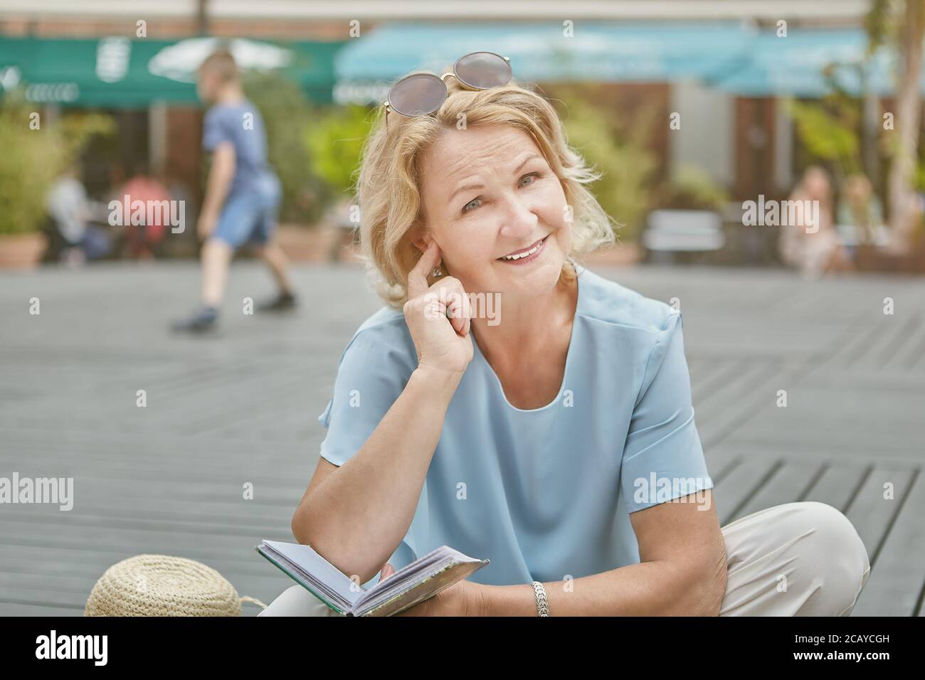 Smiling aged caucasian white woman about 62 years old has a rest in ...
