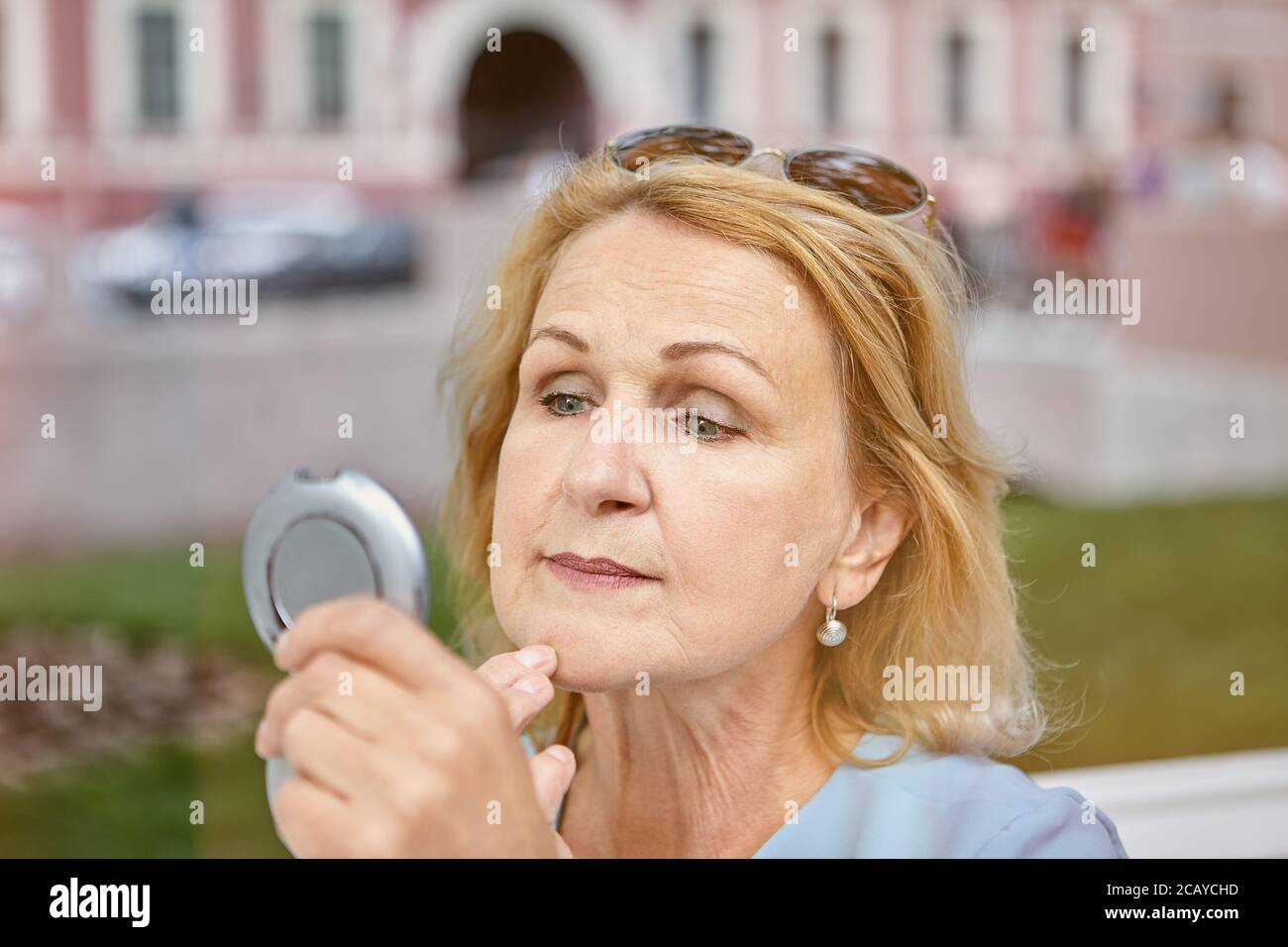 Aged caucasian white pretty businesswoman about 62 years old is walking ...