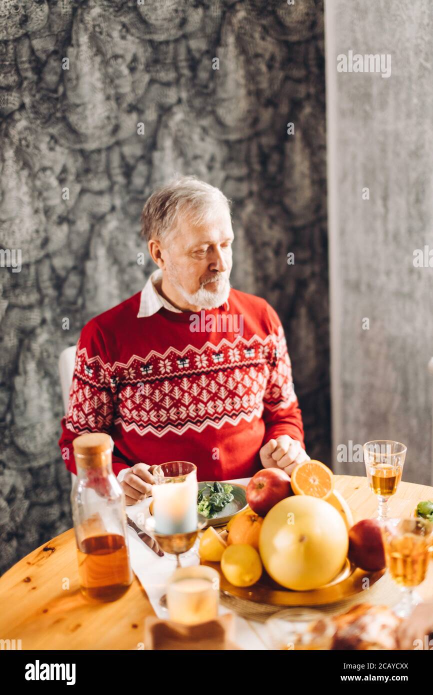 attractive old man remembers his wife during th holiday. sad memory ...